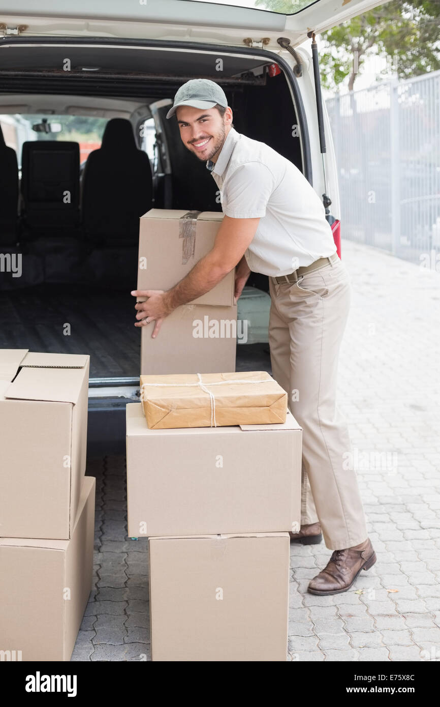 Delivery driver loading his van with boxes Stock Photo - Alamy