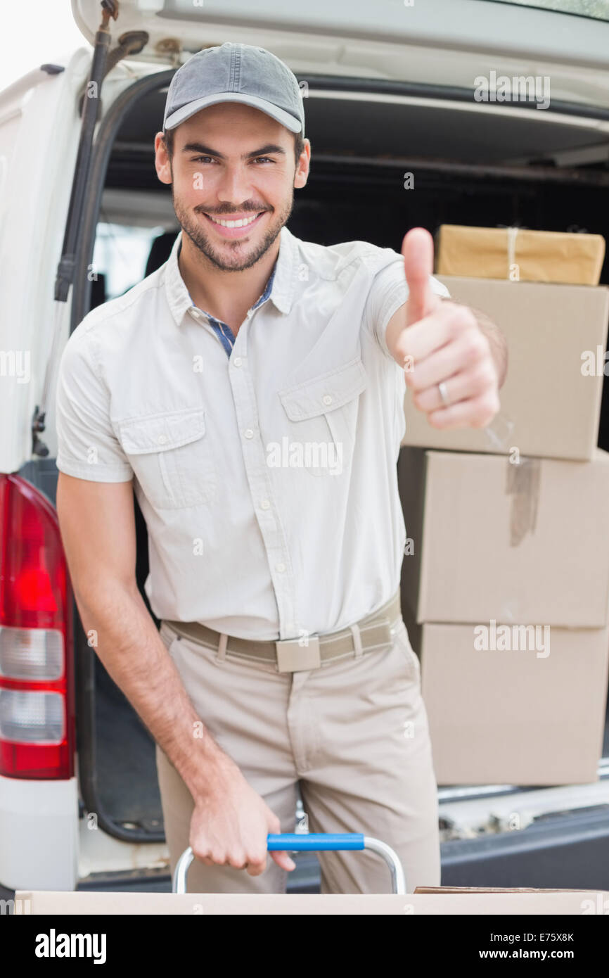 Delivery driver loading his van with boxes Stock Photo - Alamy