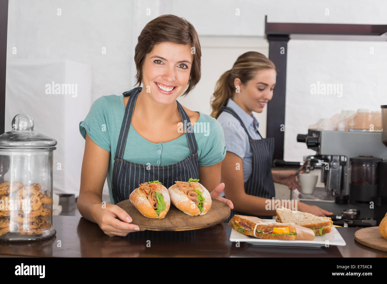 Pretty waitresses working with a smile Stock Photo - Alamy