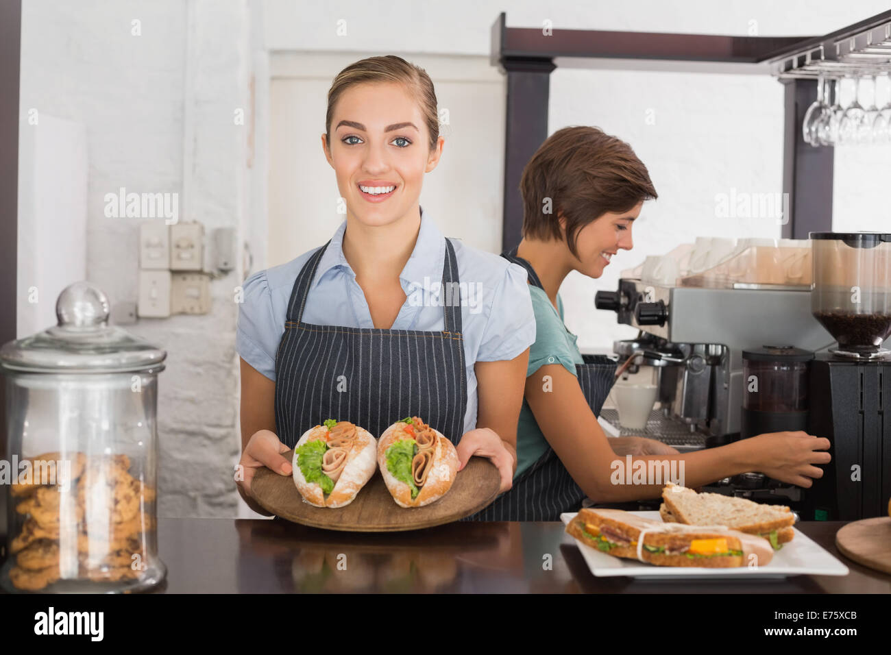 Pretty waitresses working with a smile Stock Photo - Alamy