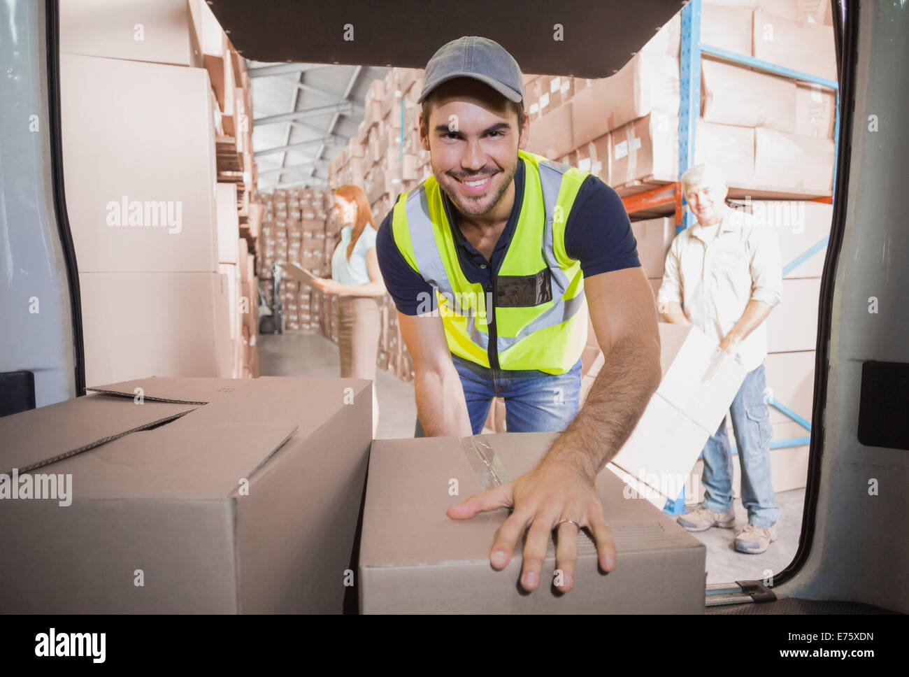 Delivery driver loading his van with boxes Stock Photo - Alamy