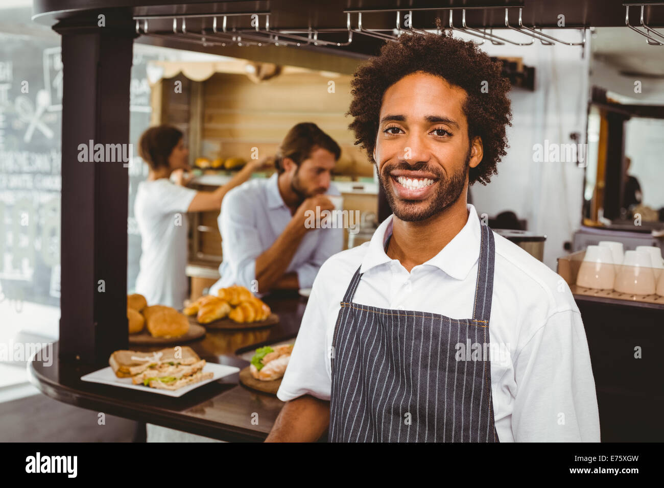 Handsome waiter smiling at camera Stock Photo - Alamy