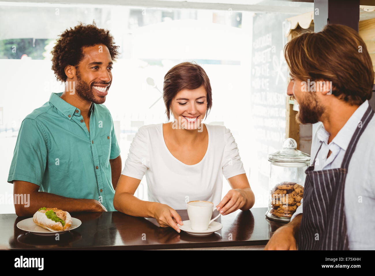 Barista talking two customers hi-res stock photography and images - Alamy