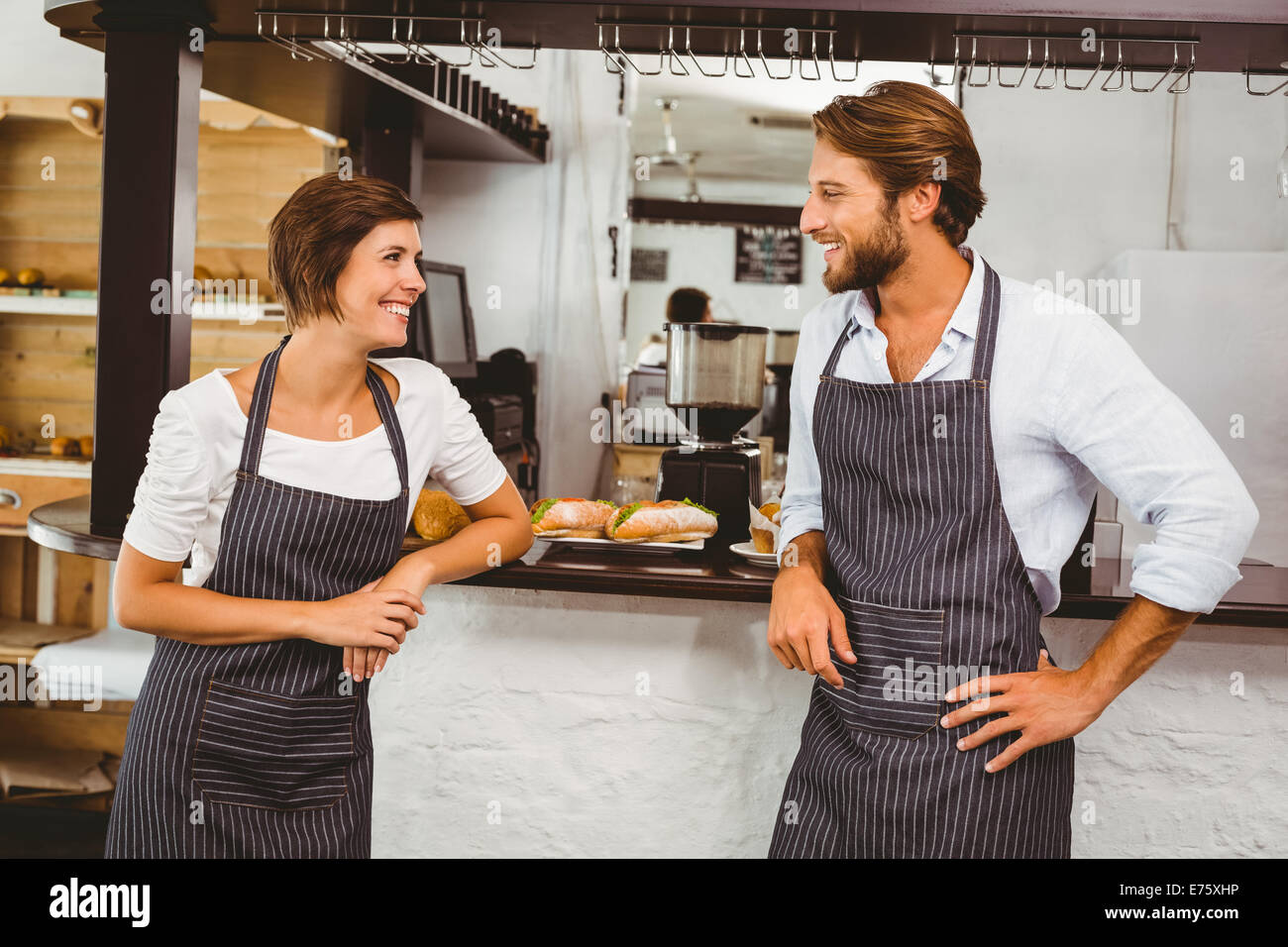 Happy servers chatting at the counter Stock Photo - Alamy