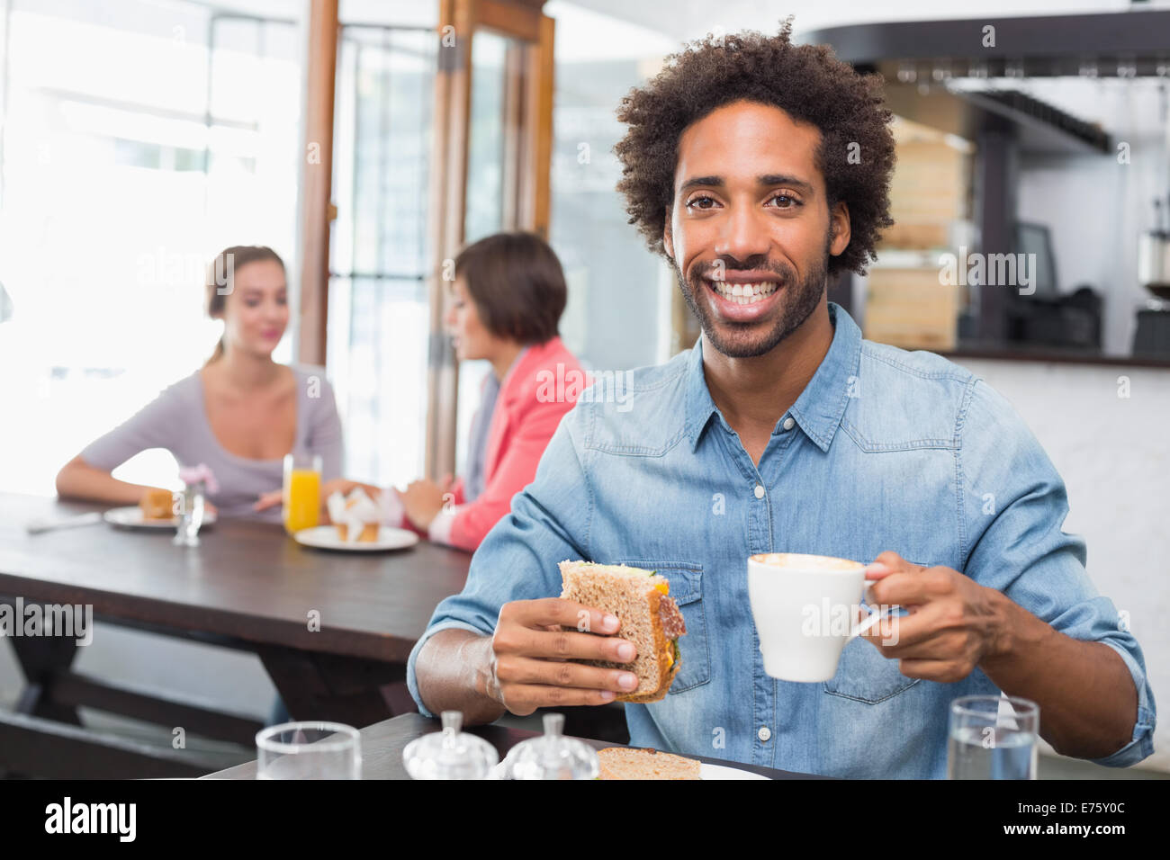 Handsome man eating a sandwich Stock Photo - Alamy