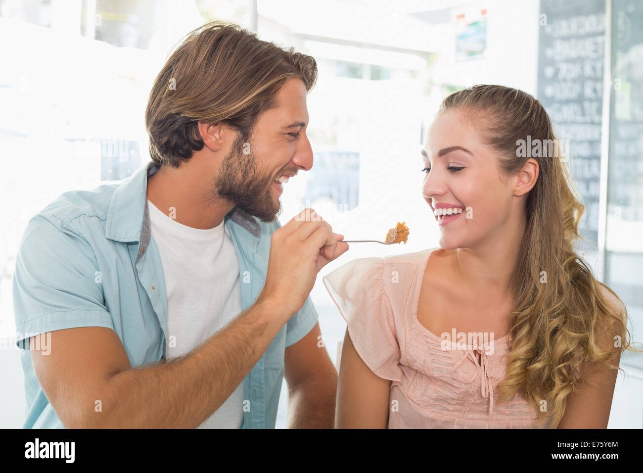 Happy couple enjoying some cake Stock Photo - Alamy