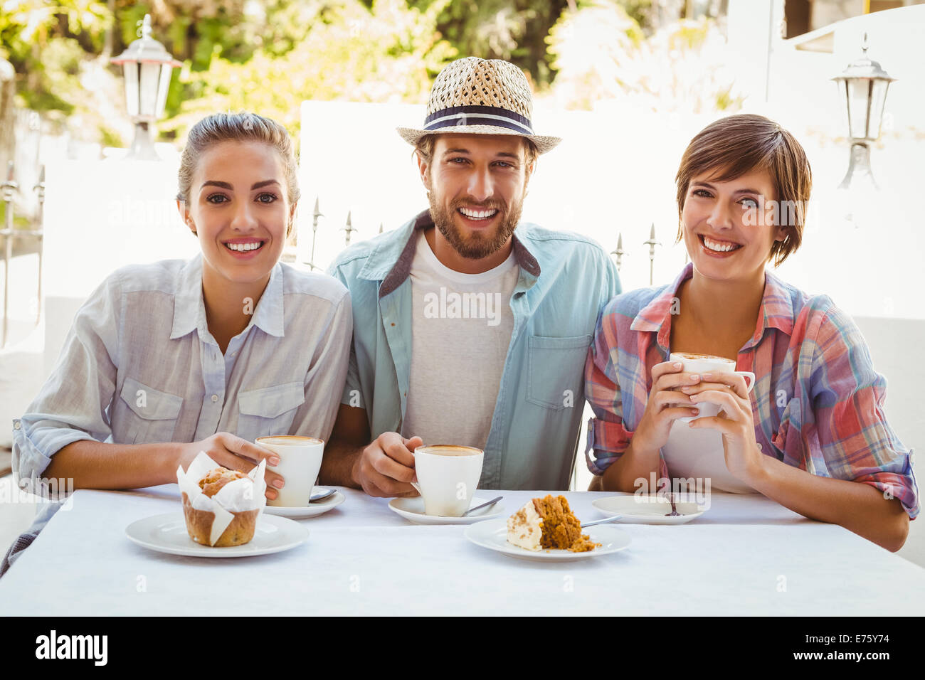 Happy friends enjoying coffee together Stock Photo - Alamy