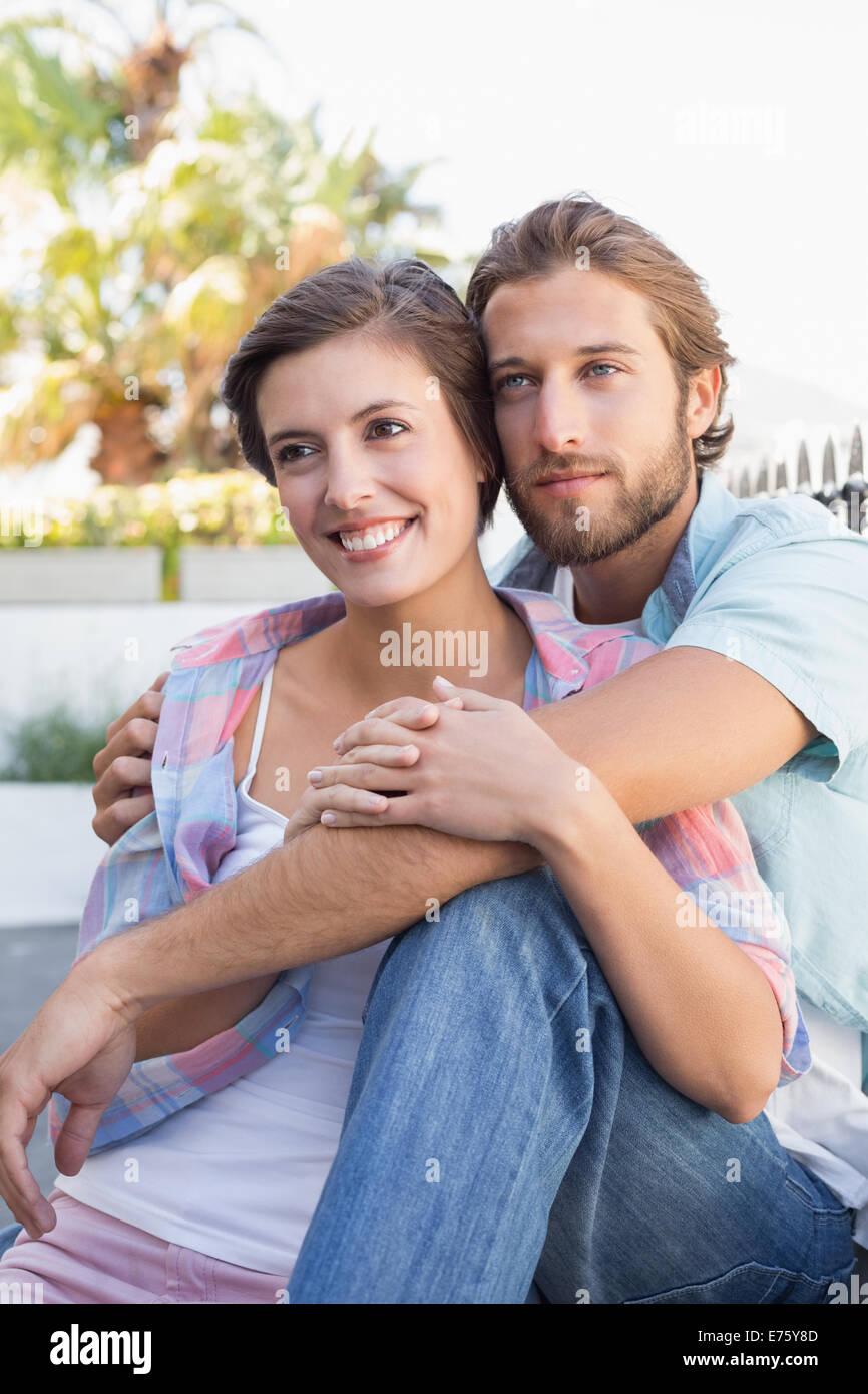 Happy couple sitting and cuddling Stock Photo - Alamy