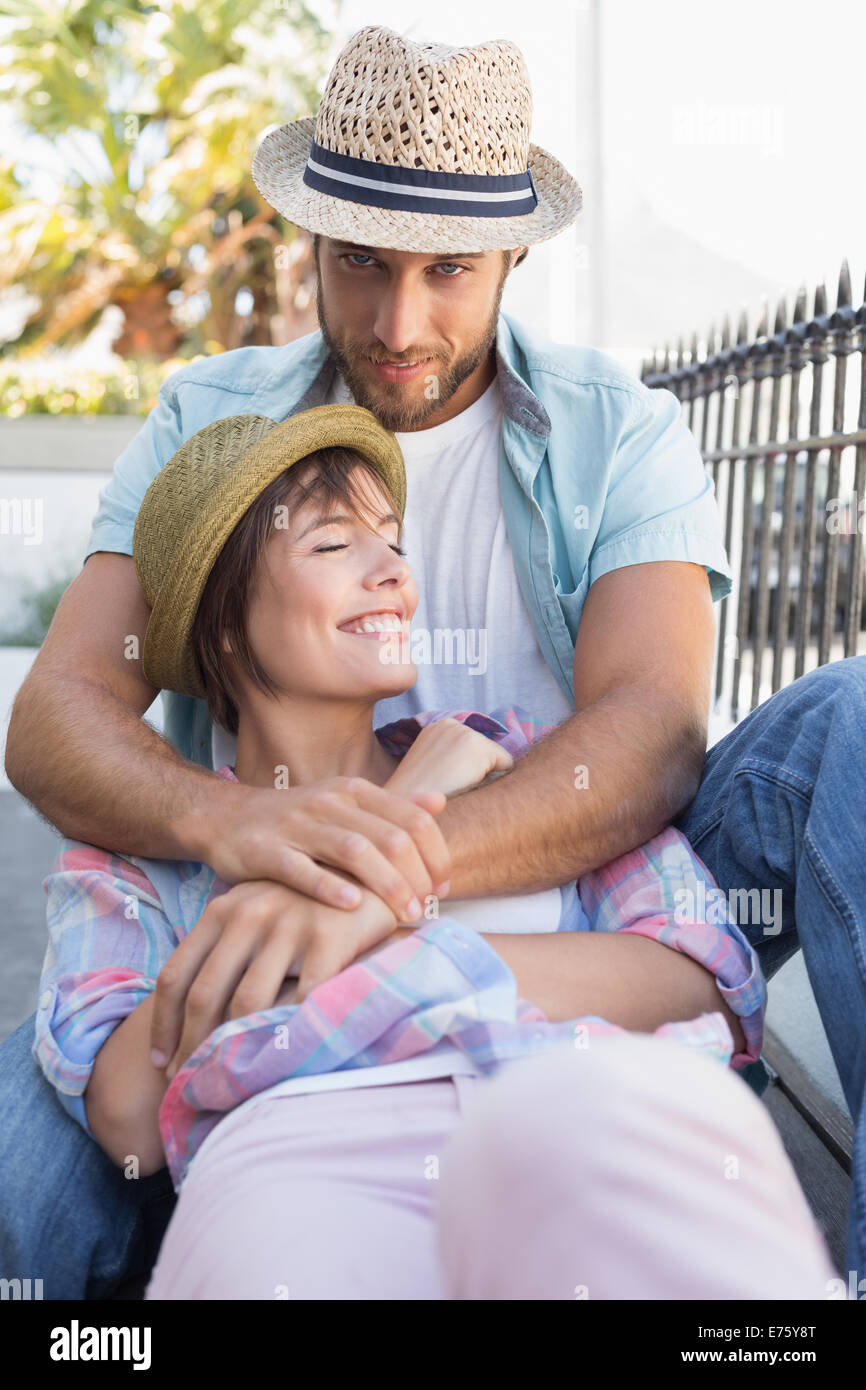 Happy couple sitting and cuddling Stock Photo - Alamy