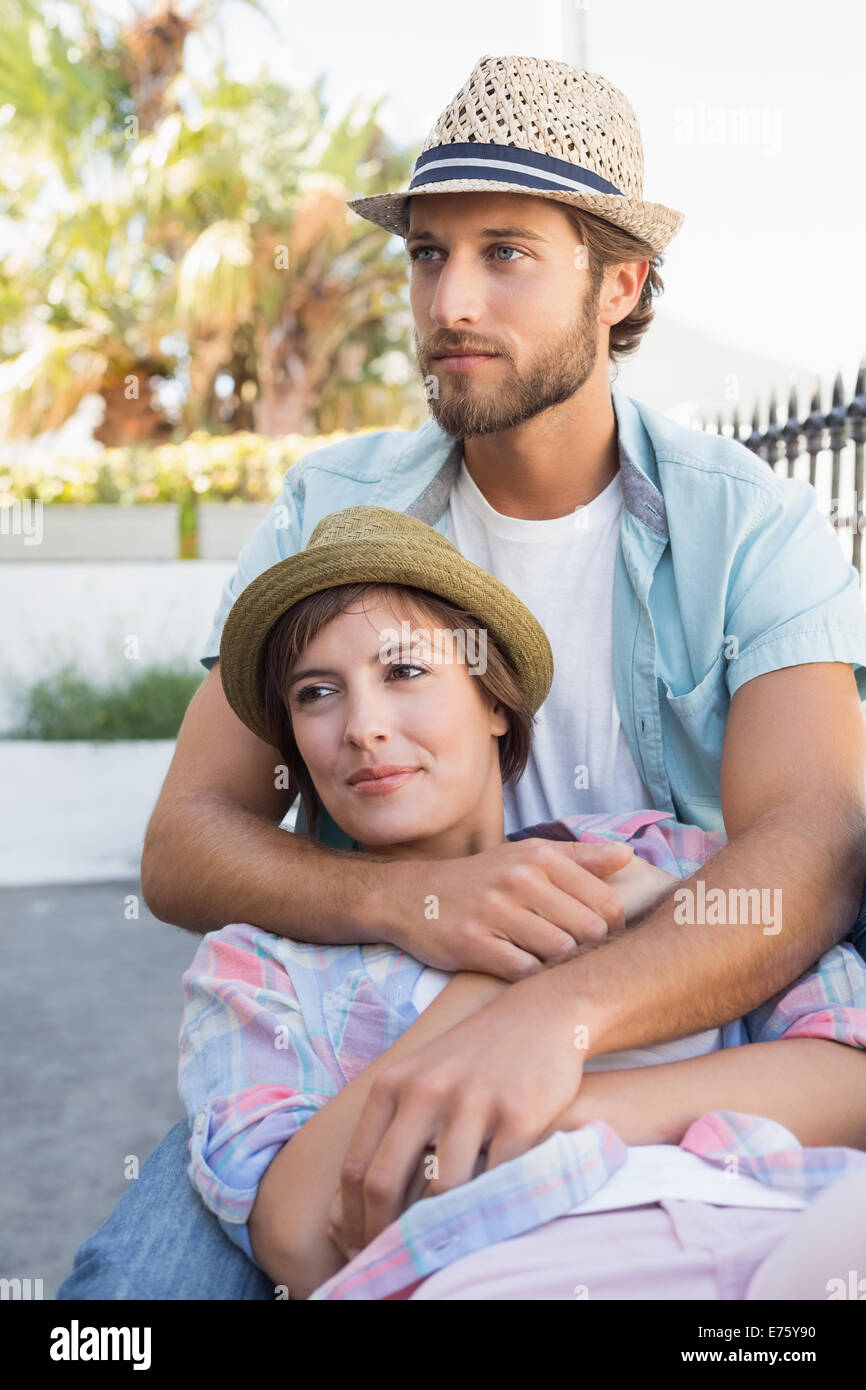 Happy couple sitting and cuddling Stock Photo - Alamy