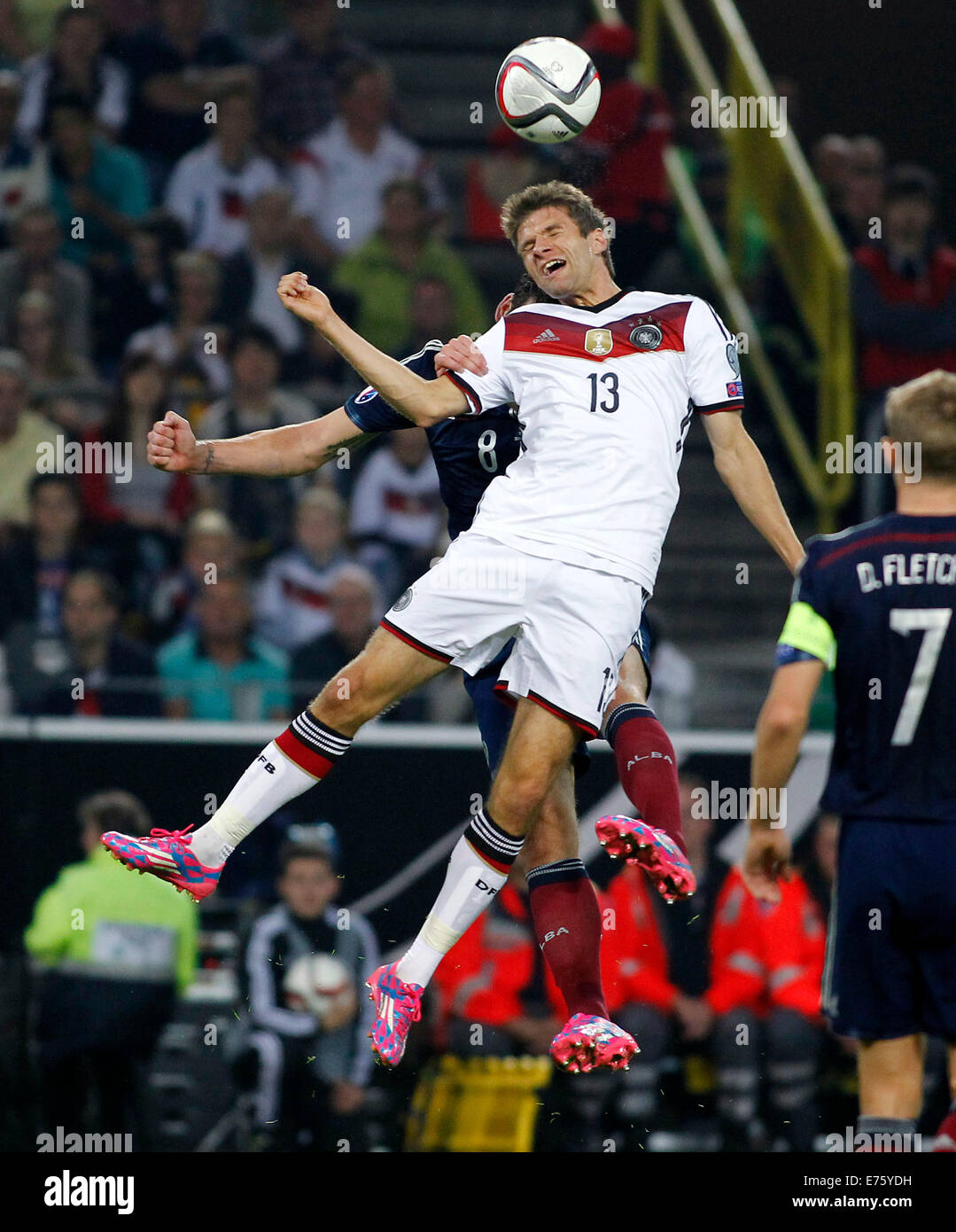 Germanys Thomas Mueller (front) jumps for a header against Scotlands ...