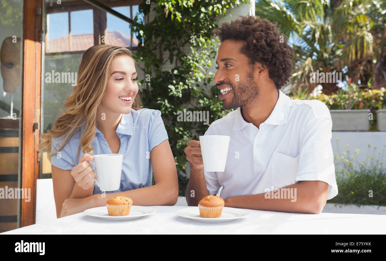 Happy friends having coffee together Stock Photo - Alamy