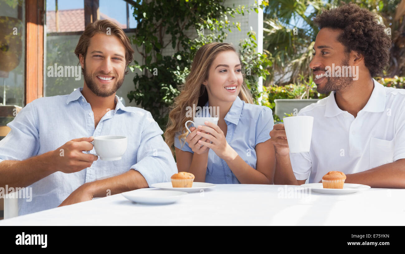 Happy friends having coffee together Stock Photo - Alamy