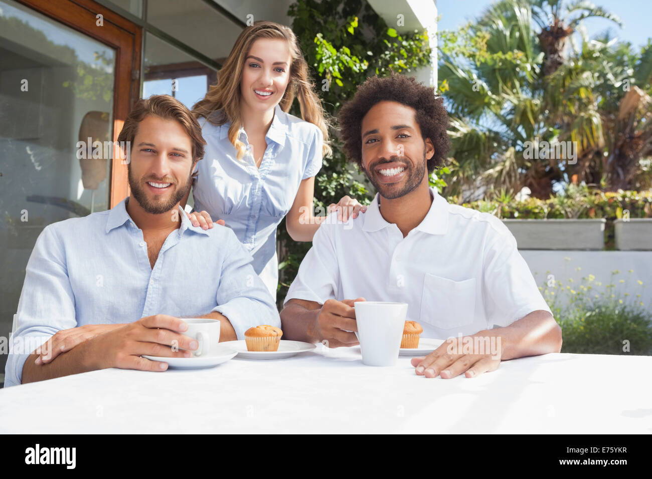 Happy friends having coffee together Stock Photo - Alamy