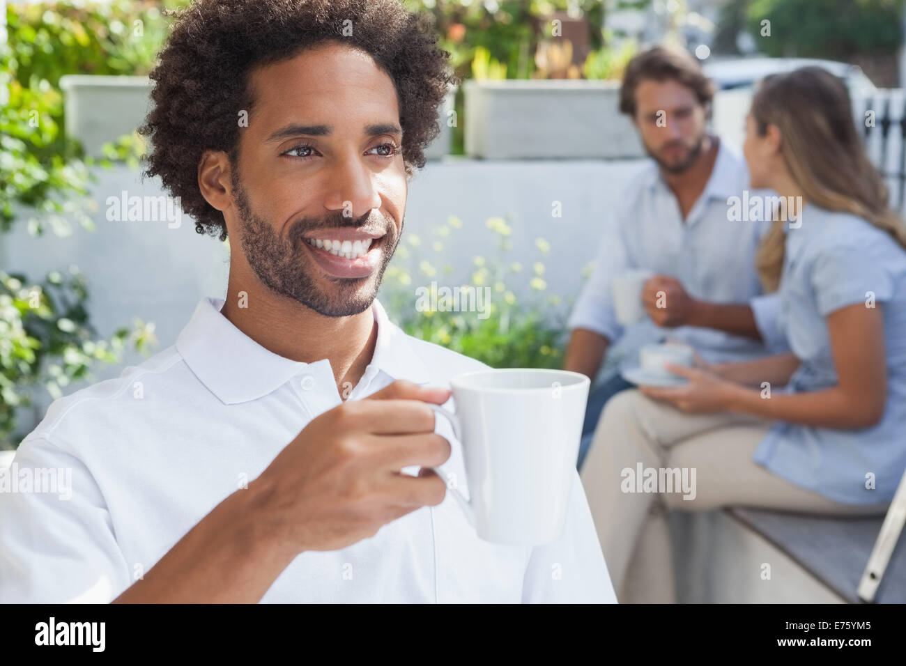 Smiling man having a coffee Stock Photo - Alamy