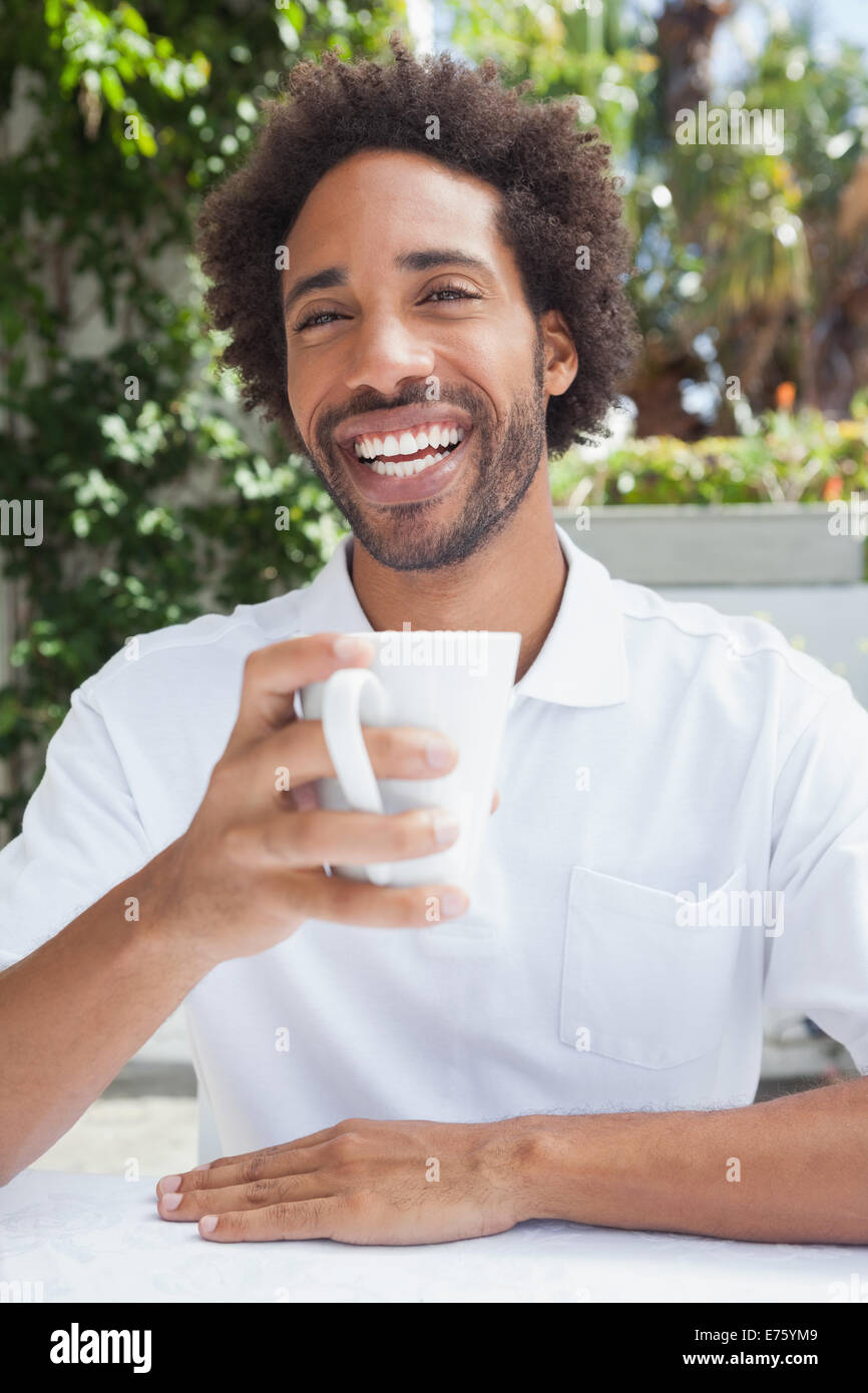 Smiling man having a coffee Stock Photo - Alamy