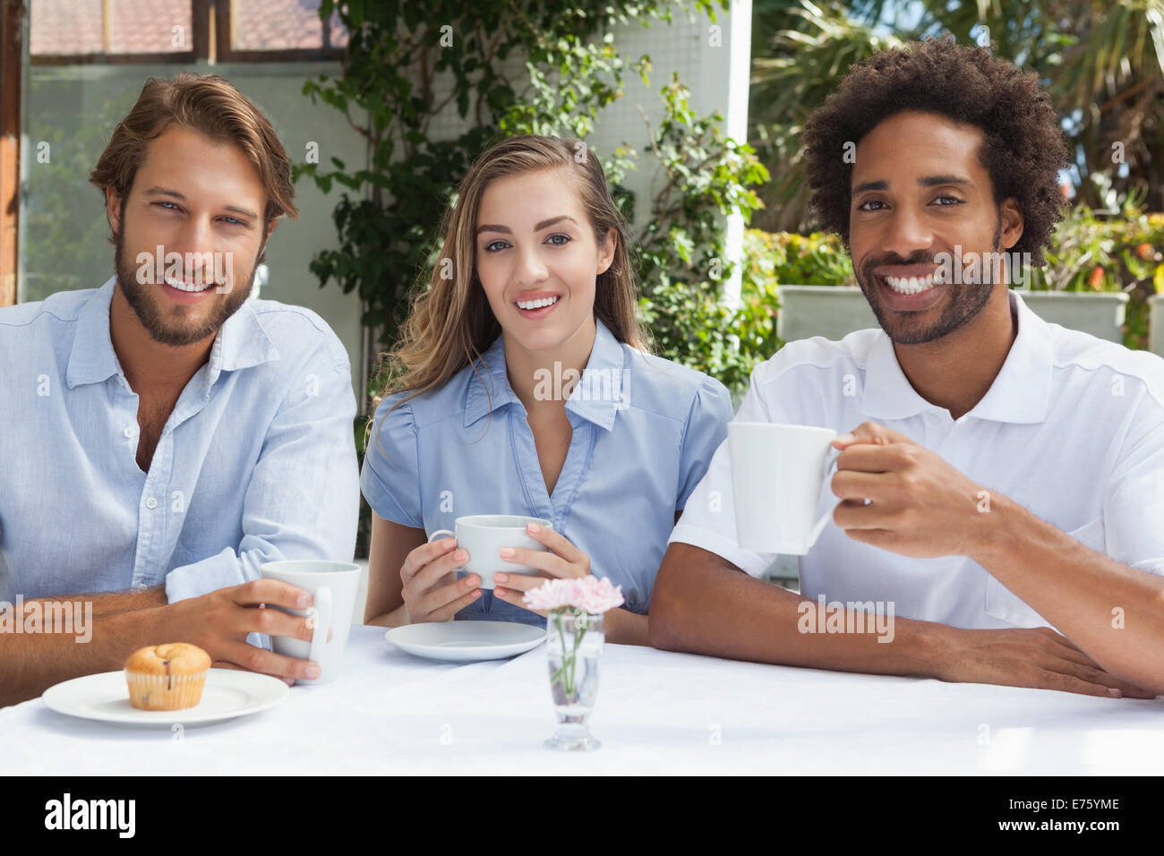 Happy friends enjoying coffee together Stock Photo - Alamy