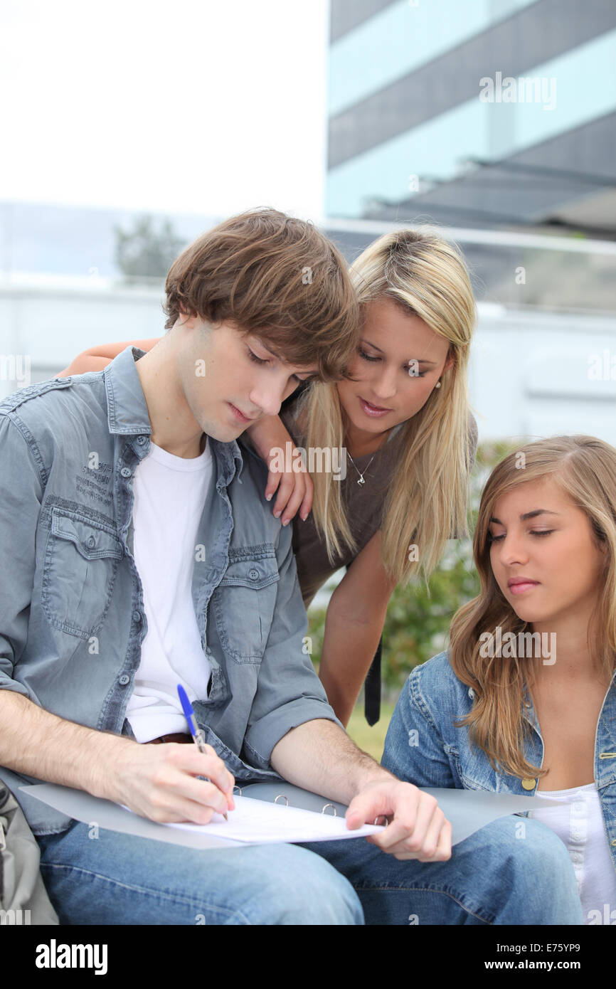 Teens taking notes Stock Photo - Alamy