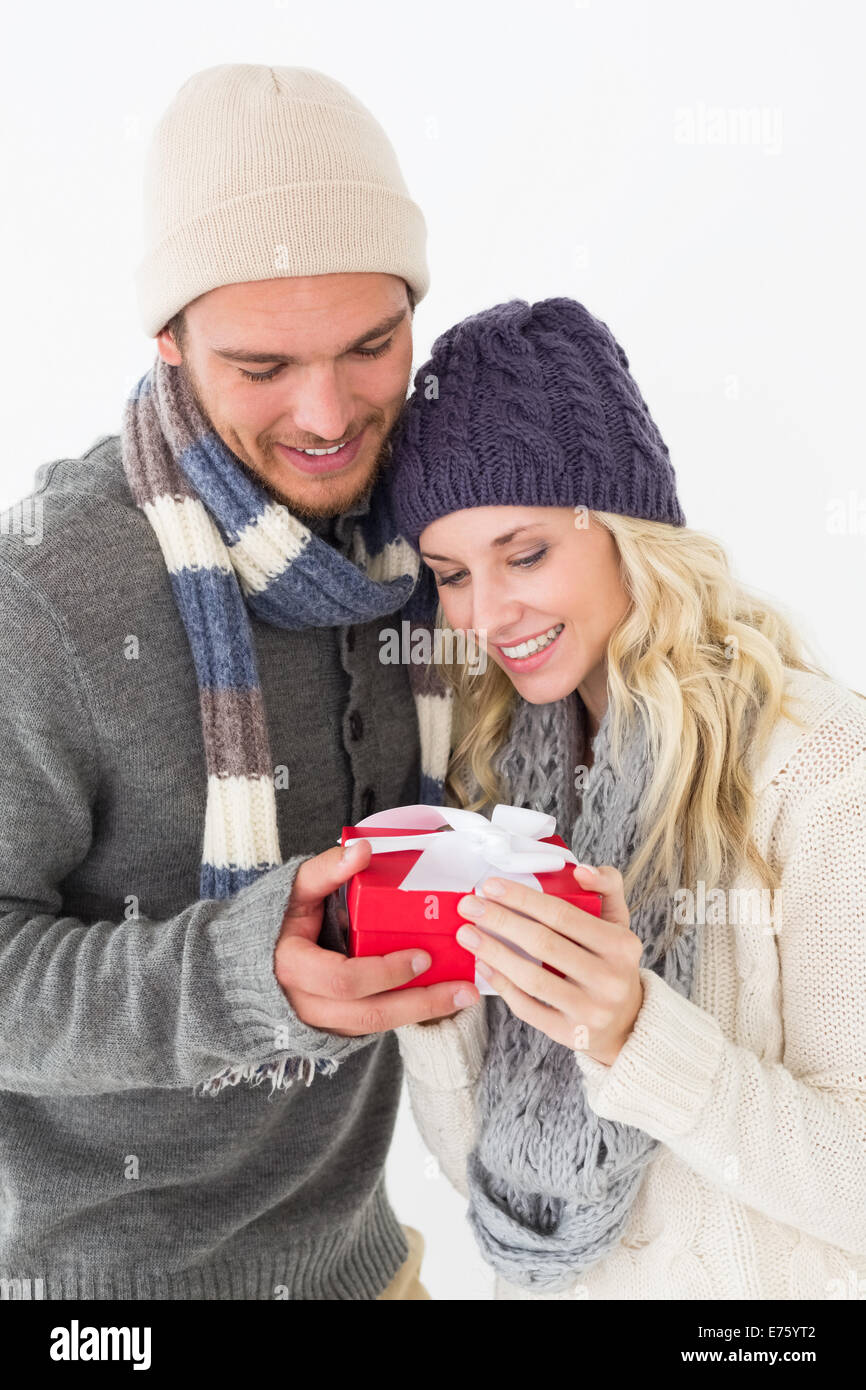 Attractive couple in warm clothing holding gift Stock Photo - Alamy