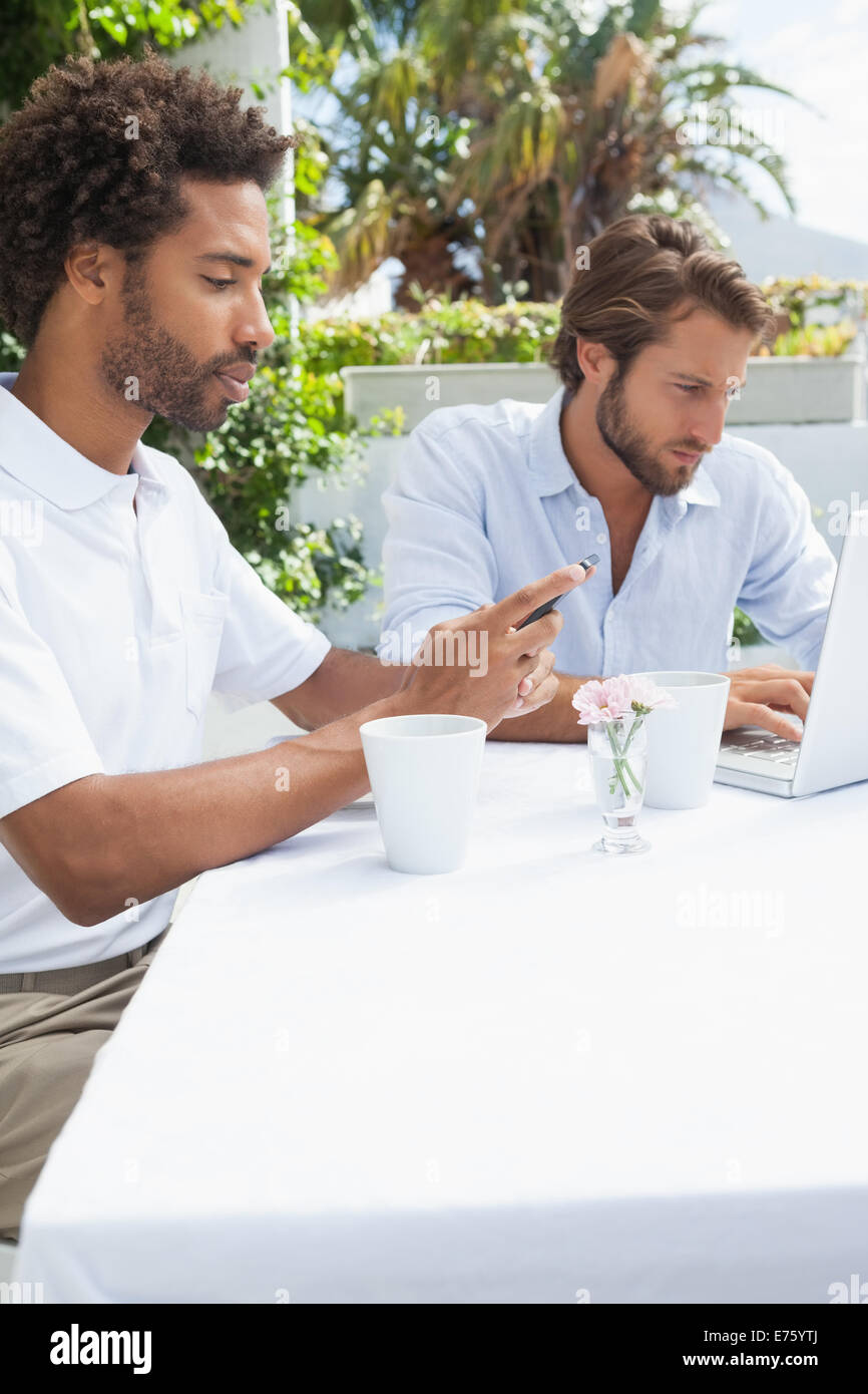 Two busy friends having coffee together Stock Photo - Alamy