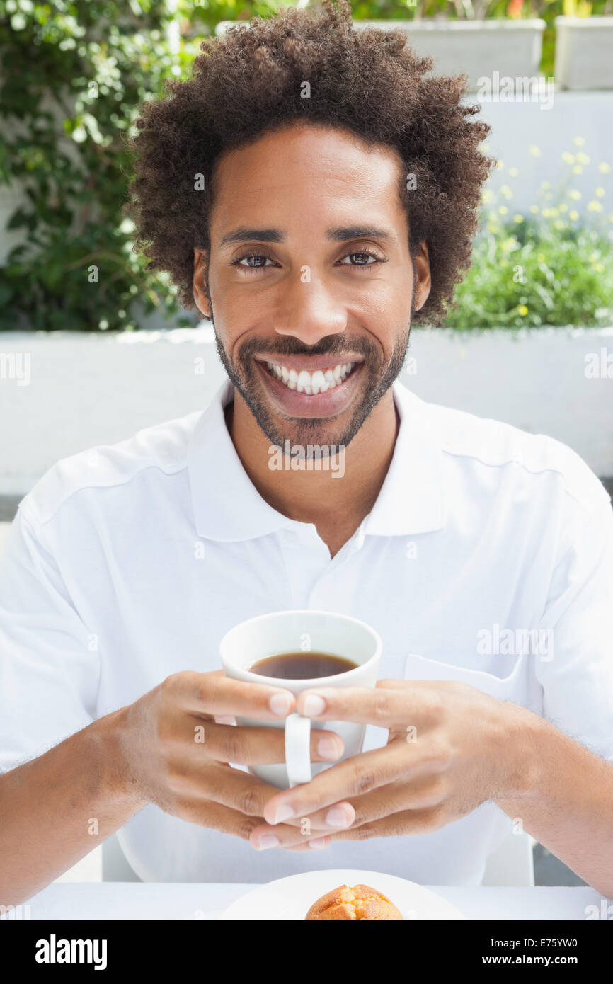 Smiling man having a coffee Stock Photo - Alamy