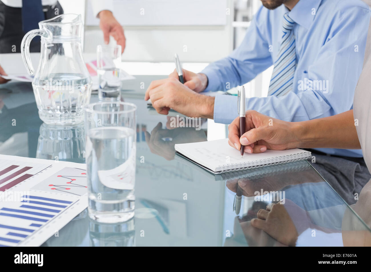 Business team writing some notes Stock Photo - Alamy