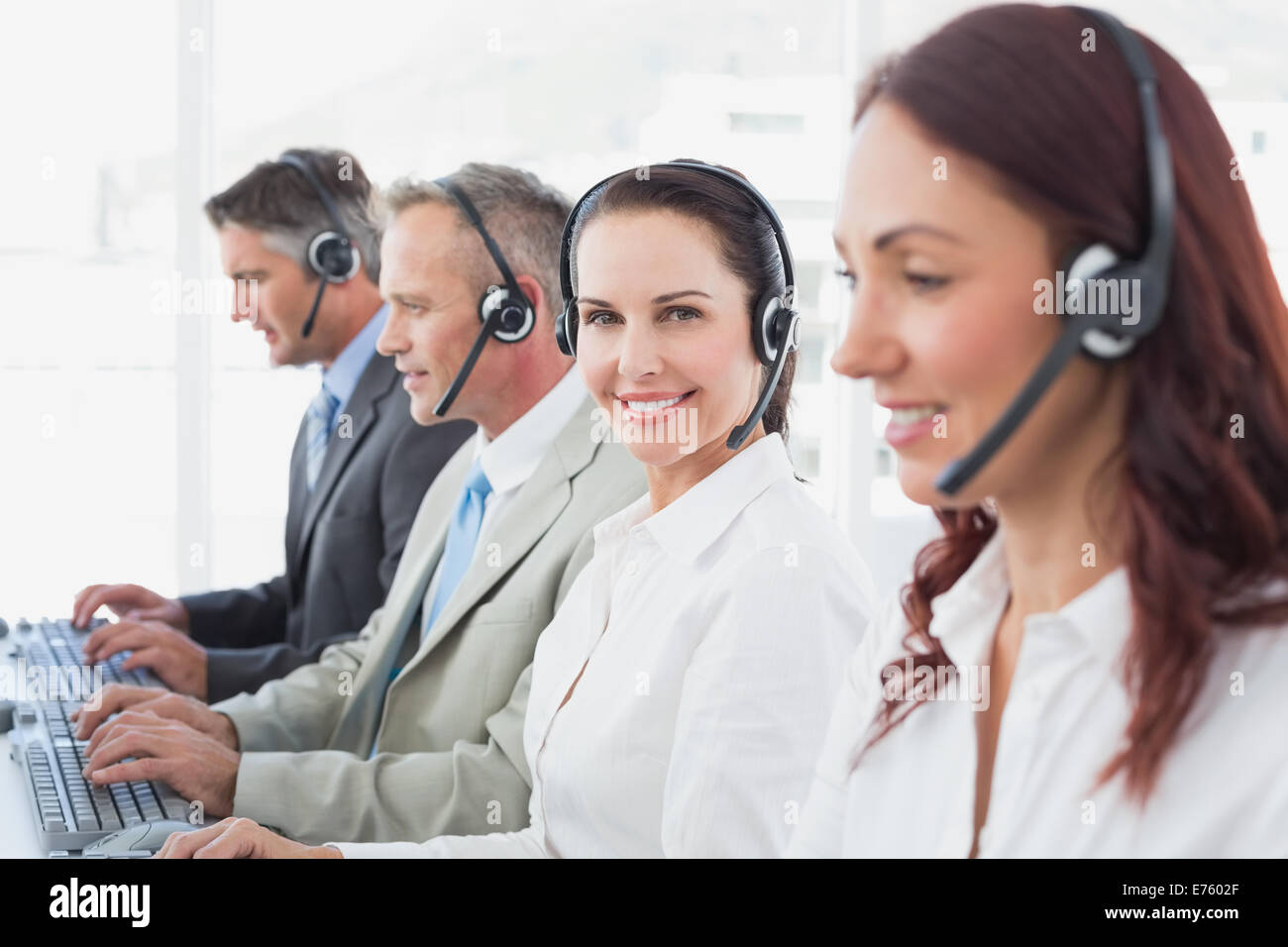 Call center workers all smiling Stock Photo - Alamy