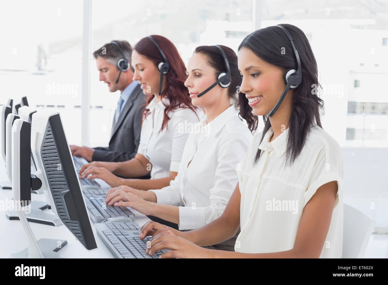 Employee's typing on their computers Stock Photo - Alamy