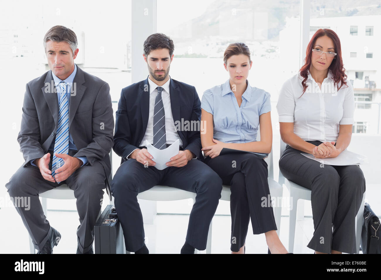 Business people sitting in a row Stock Photo - Alamy