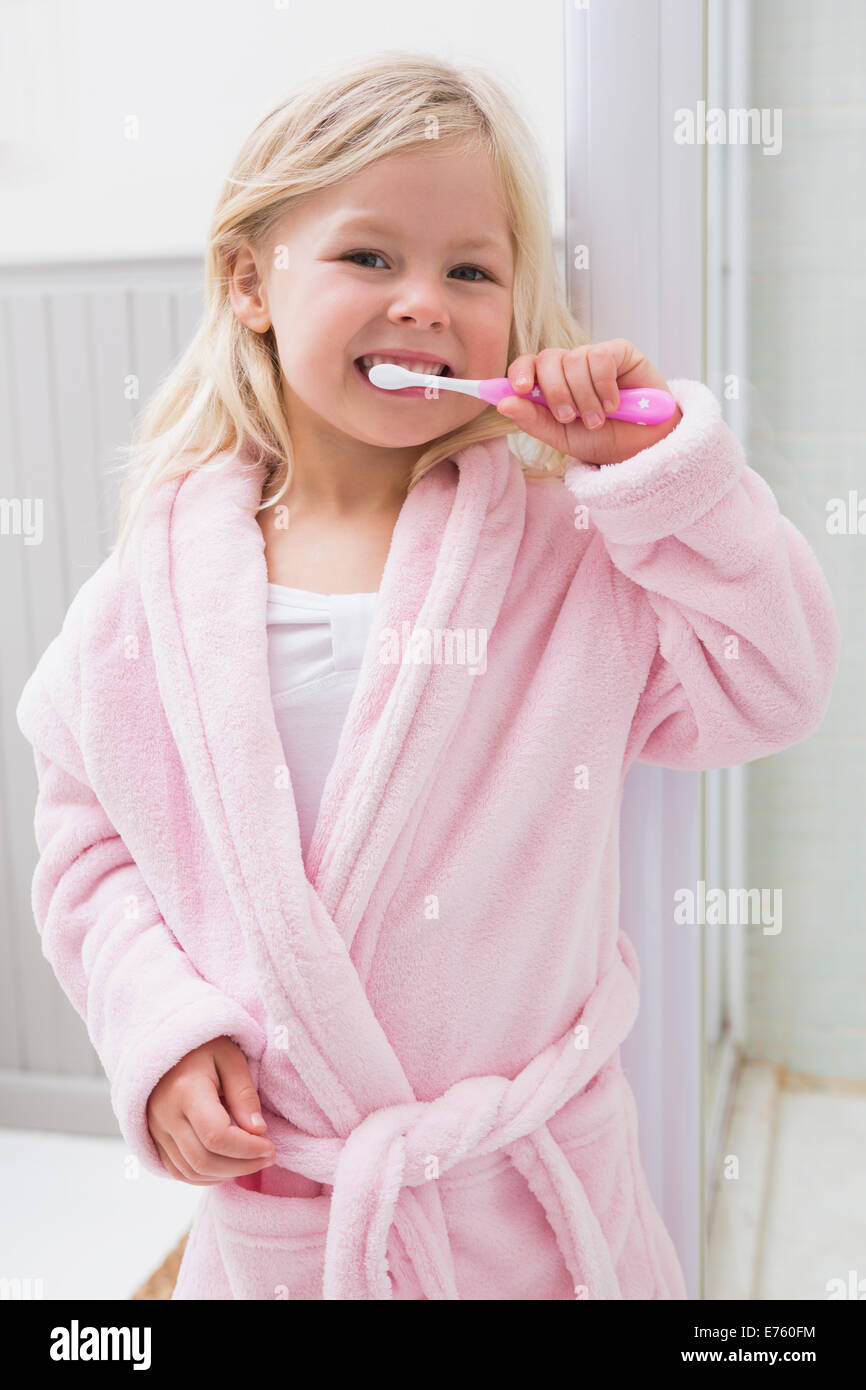 Cute girl brushing her teeth Stock Photo - Alamy