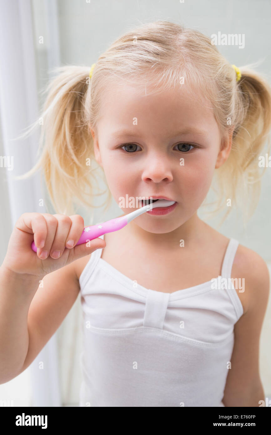 Cute girl brushing her teeth Stock Photo - Alamy