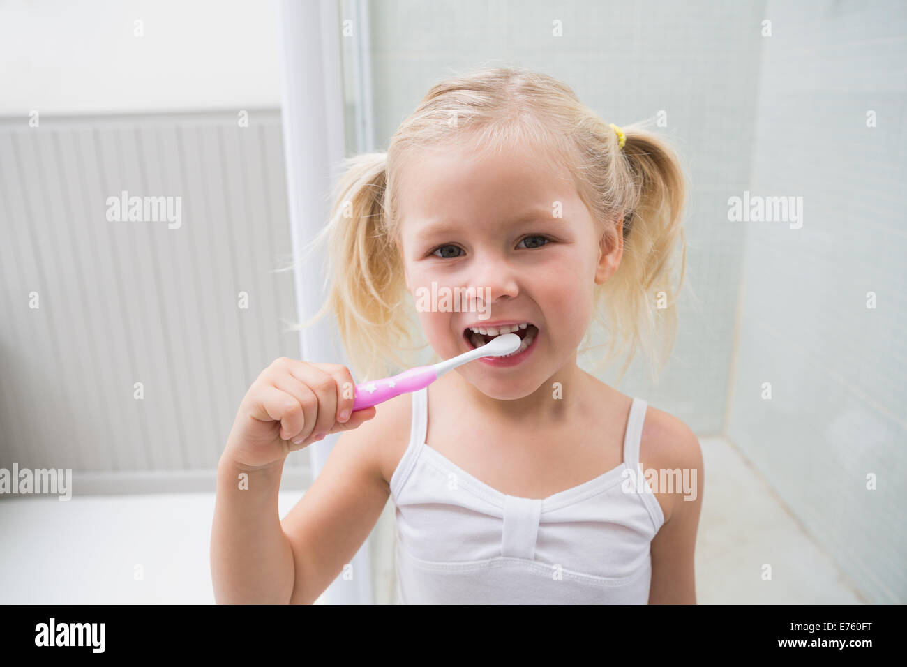 Cute girl brushing her teeth Stock Photo - Alamy