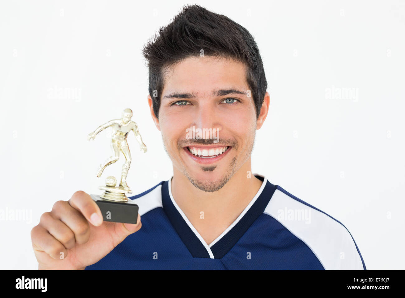 Football player holding winners trophy Stock Photo - Alamy