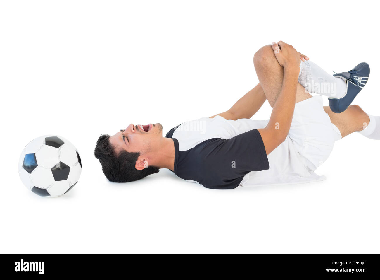 Soccer player lying down and shouting in pain Stock Photo - Alamy