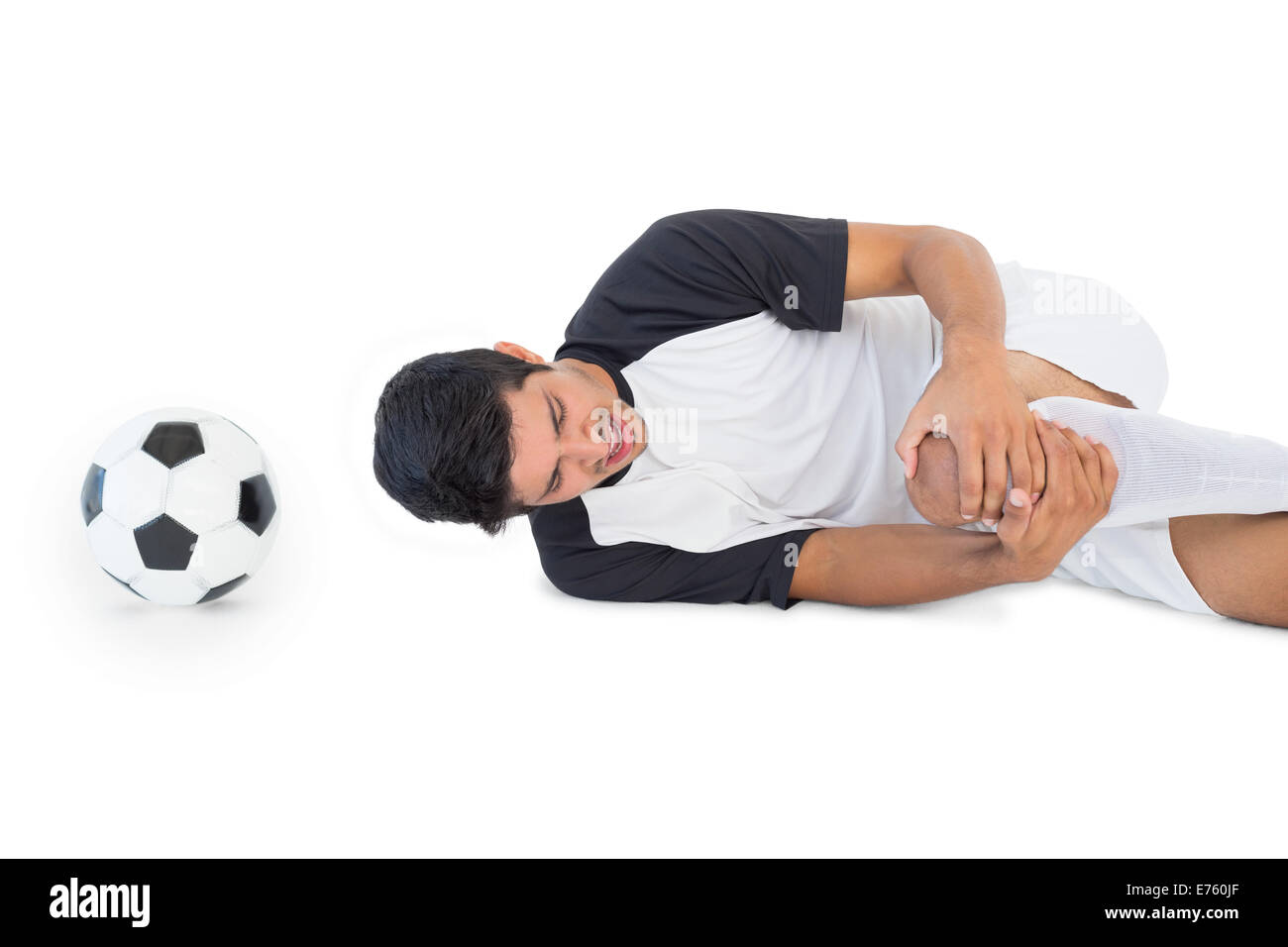 Soccer player lying down and shouting in pain Stock Photo - Alamy