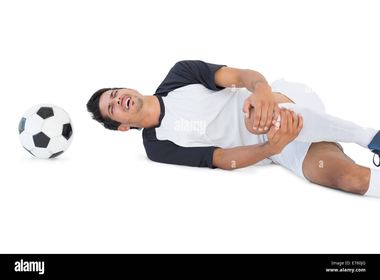 Soccer player lying down and shouting in pain Stock Photo - Alamy