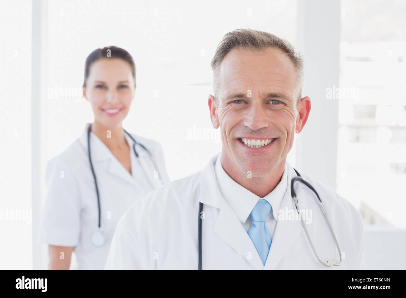 Doctor smiling at the camera Stock Photo - Alamy