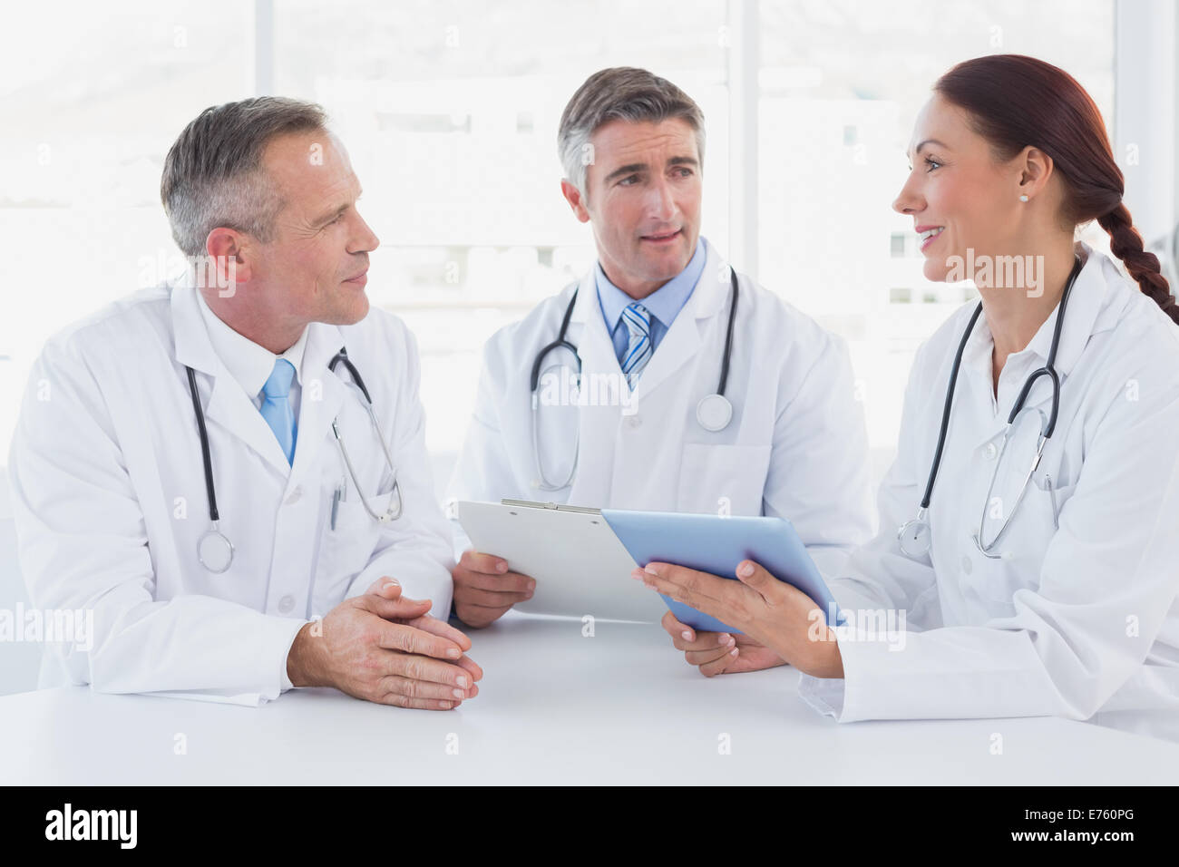 Doctors using a tablet together Stock Photo - Alamy