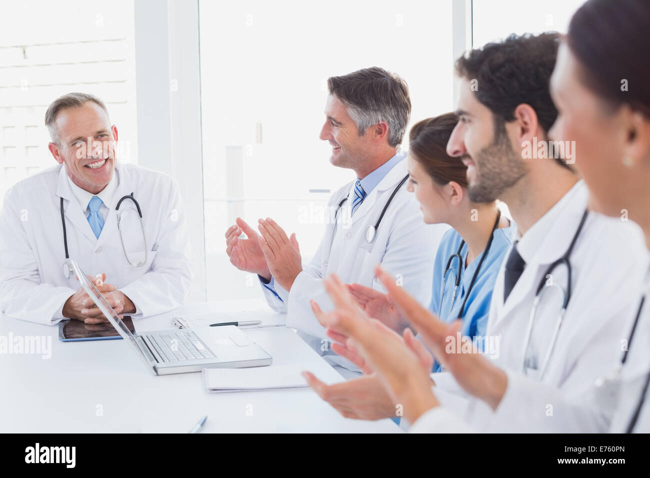 Doctors applauding a fellow doctor Stock Photo - Alamy
