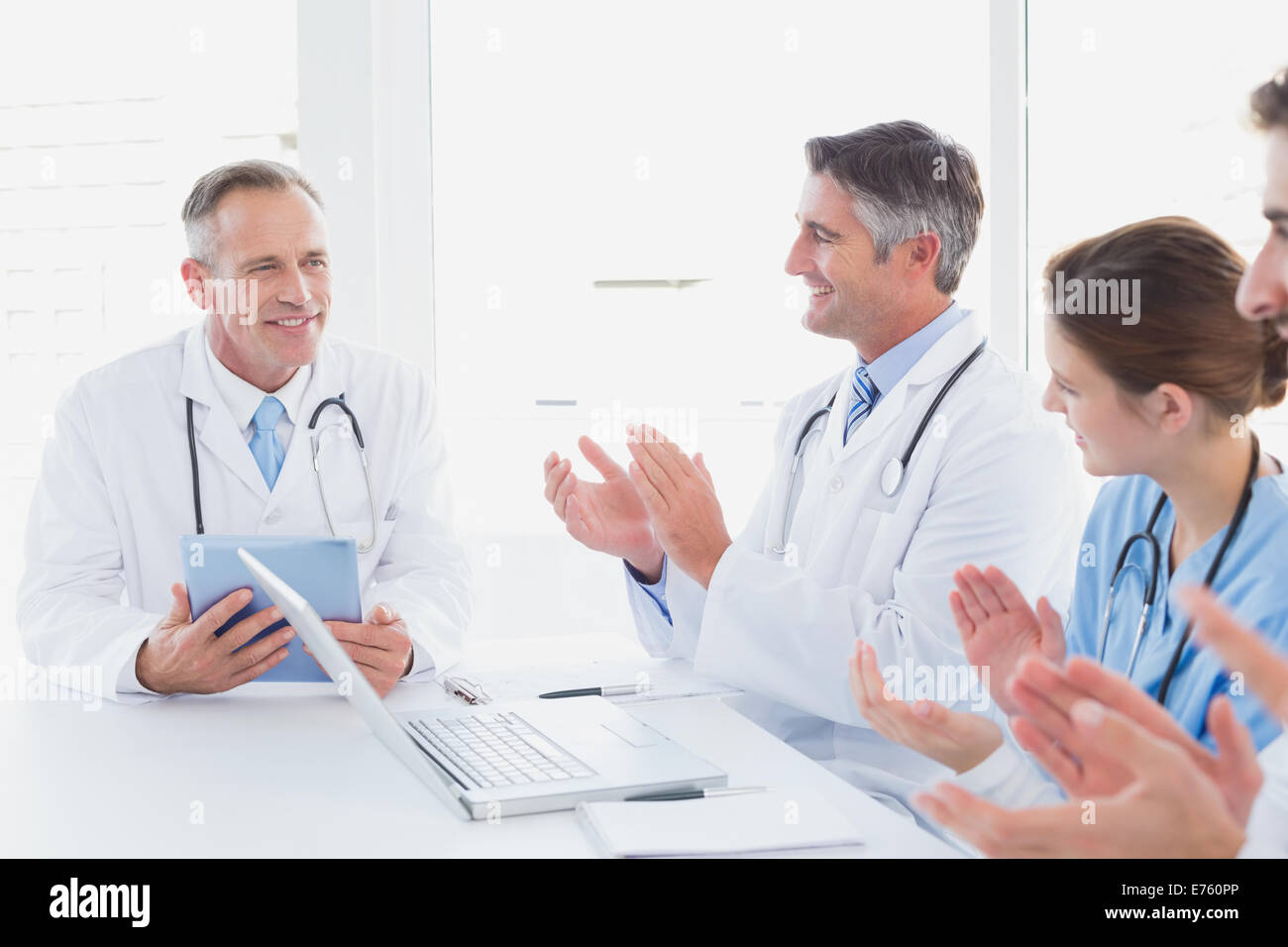 Doctors applauding a fellow doctor Stock Photo - Alamy