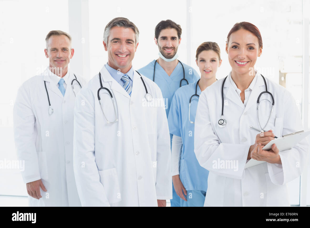 Smiling doctors all standing together Stock Photo - Alamy