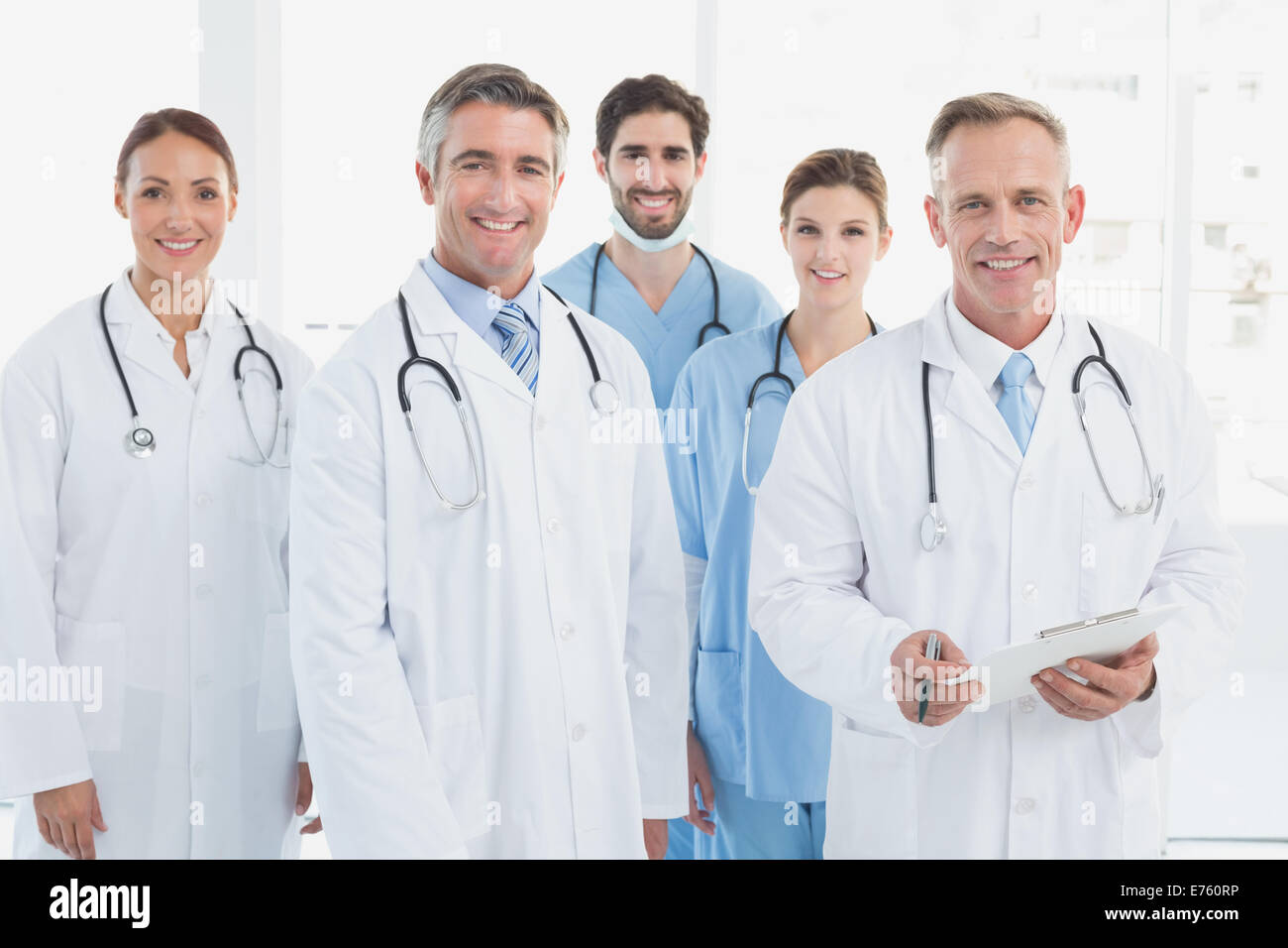 Smiling doctors all standing together Stock Photo - Alamy
