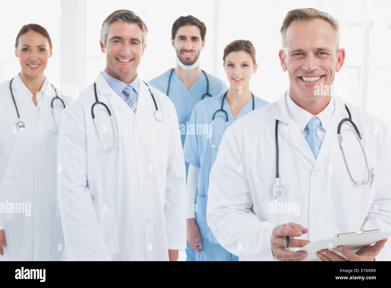 Smiling doctors all standing together Stock Photo - Alamy