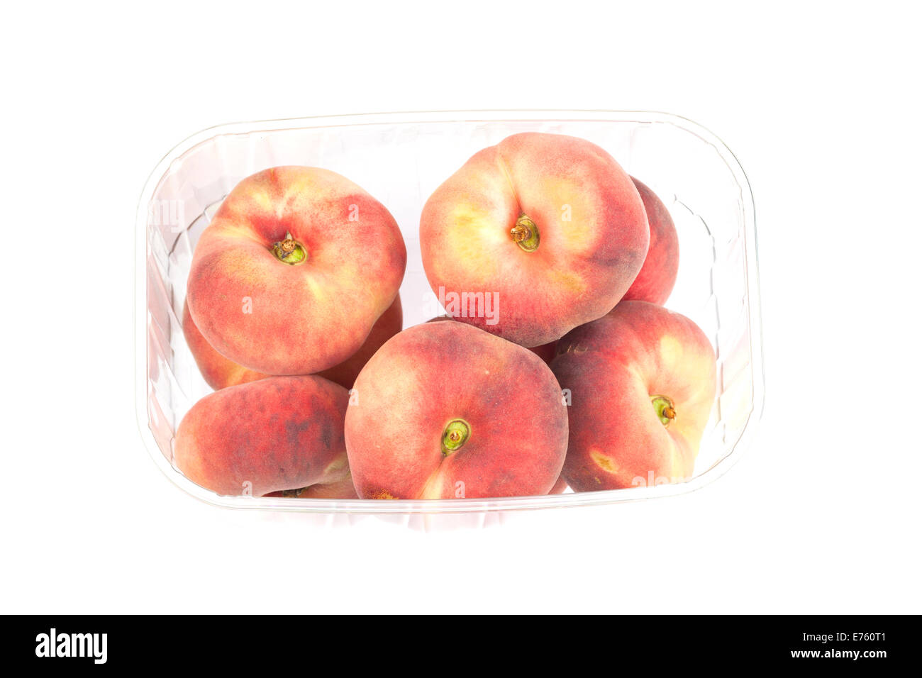 Saturn peaches in a punnet on a white background Stock Photo - Alamy