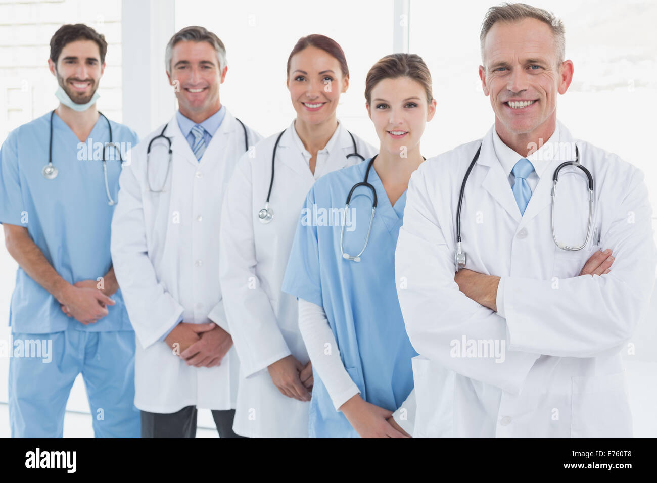 Smiling doctors all standing together Stock Photo - Alamy