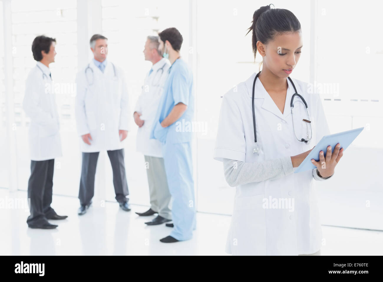 Doctor looking over medical notes Stock Photo - Alamy