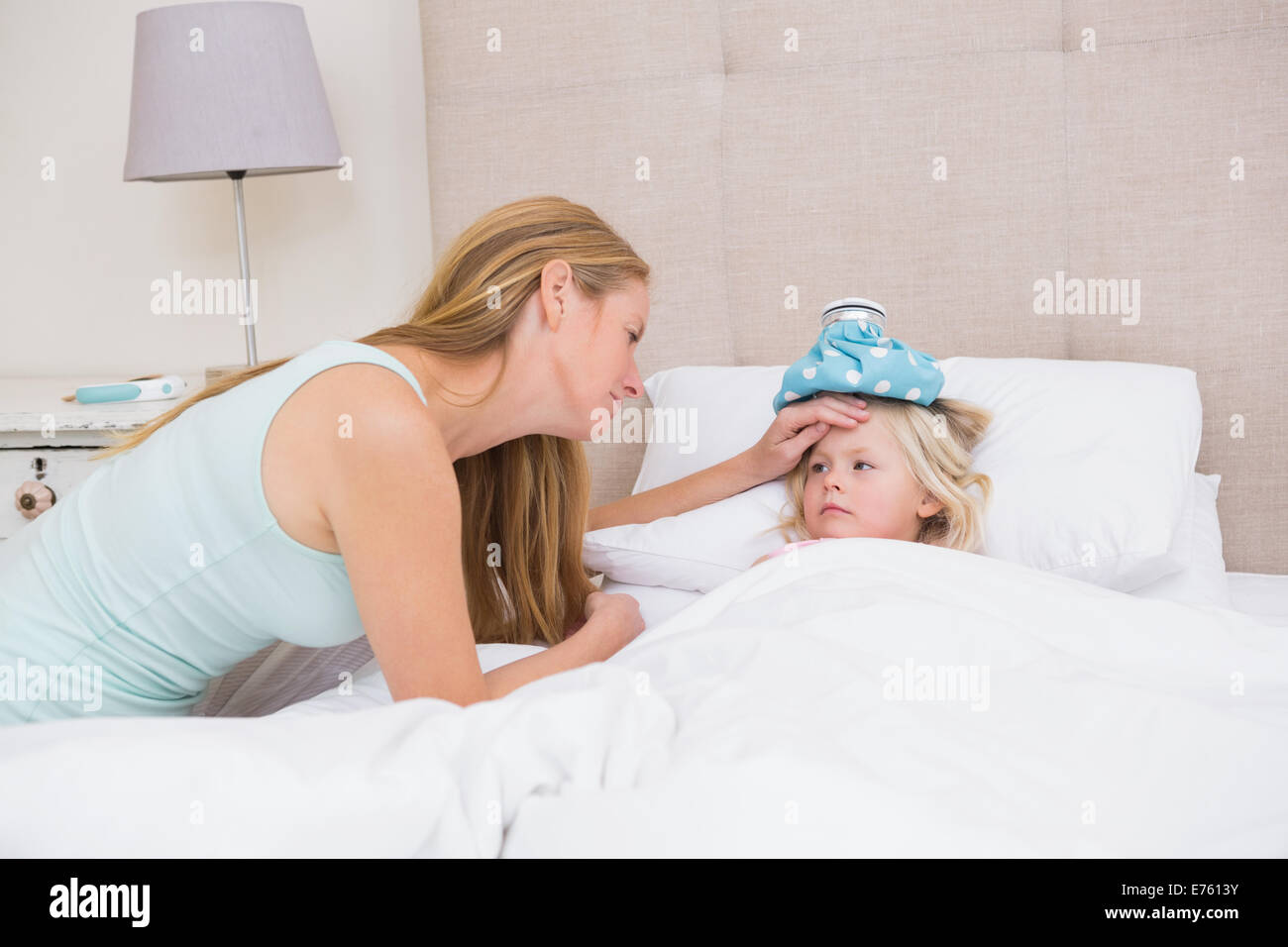Cute sick girl being looked after Stock Photo - Alamy