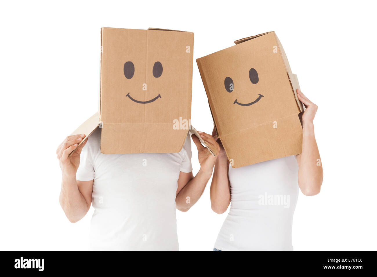 Couple wearing happy face boxes over heads Stock Photo - Alamy