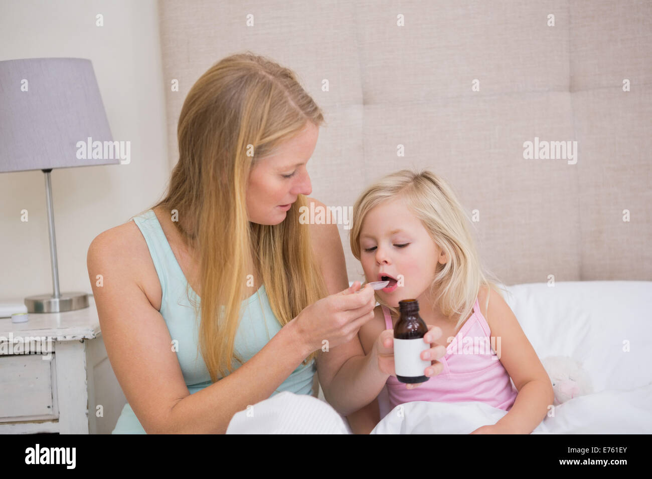 Cute sick girl being looked after Stock Photo - Alamy