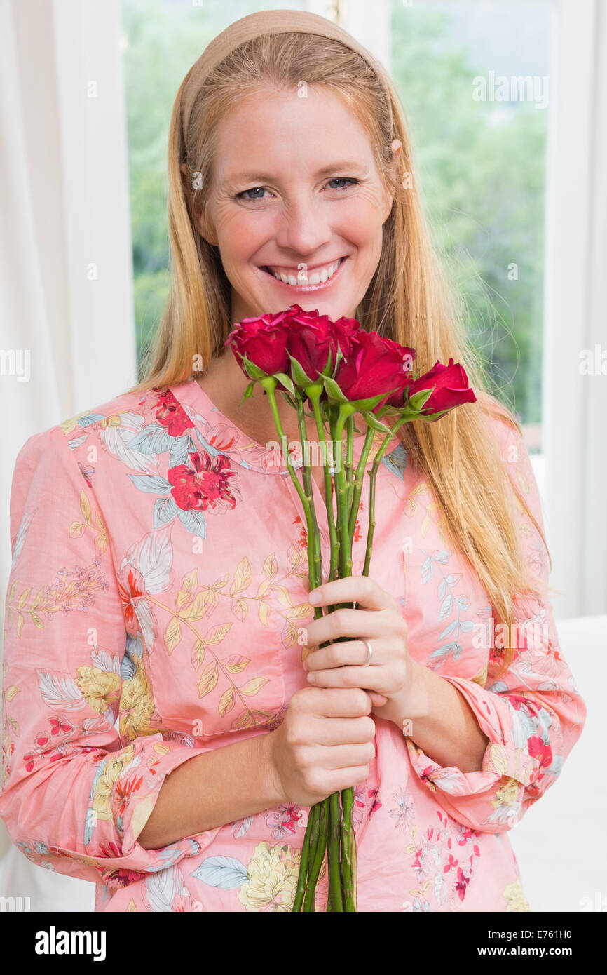Happy woman holding red roses Stock Photo - Alamy